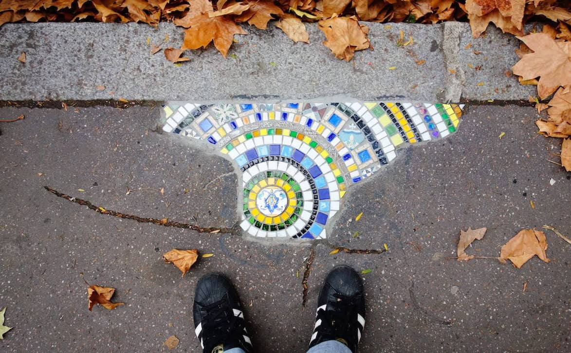 The guerrilla artist filling Europe’s potholes with colourful mosaics ...